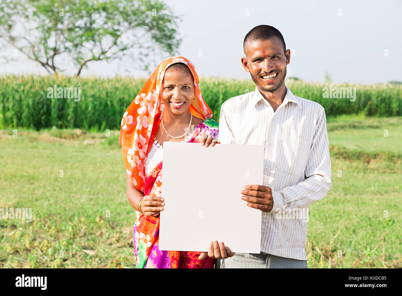 2 Indian Rural Villager Couple Showing Message Board Smiling farm Stock ...