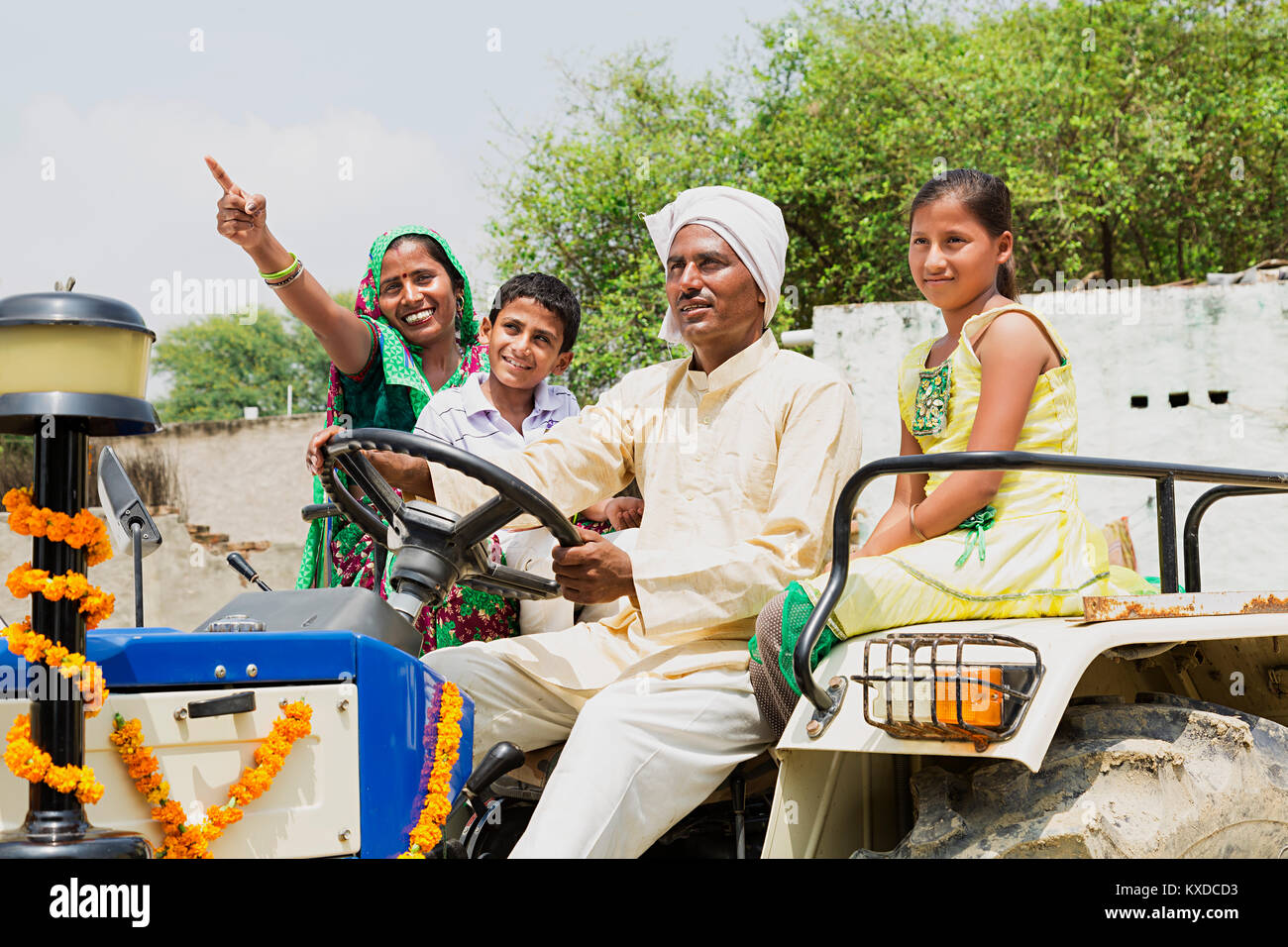 Indian Farmer Family Parents And Kids Riding Tractor Pointing Something ...