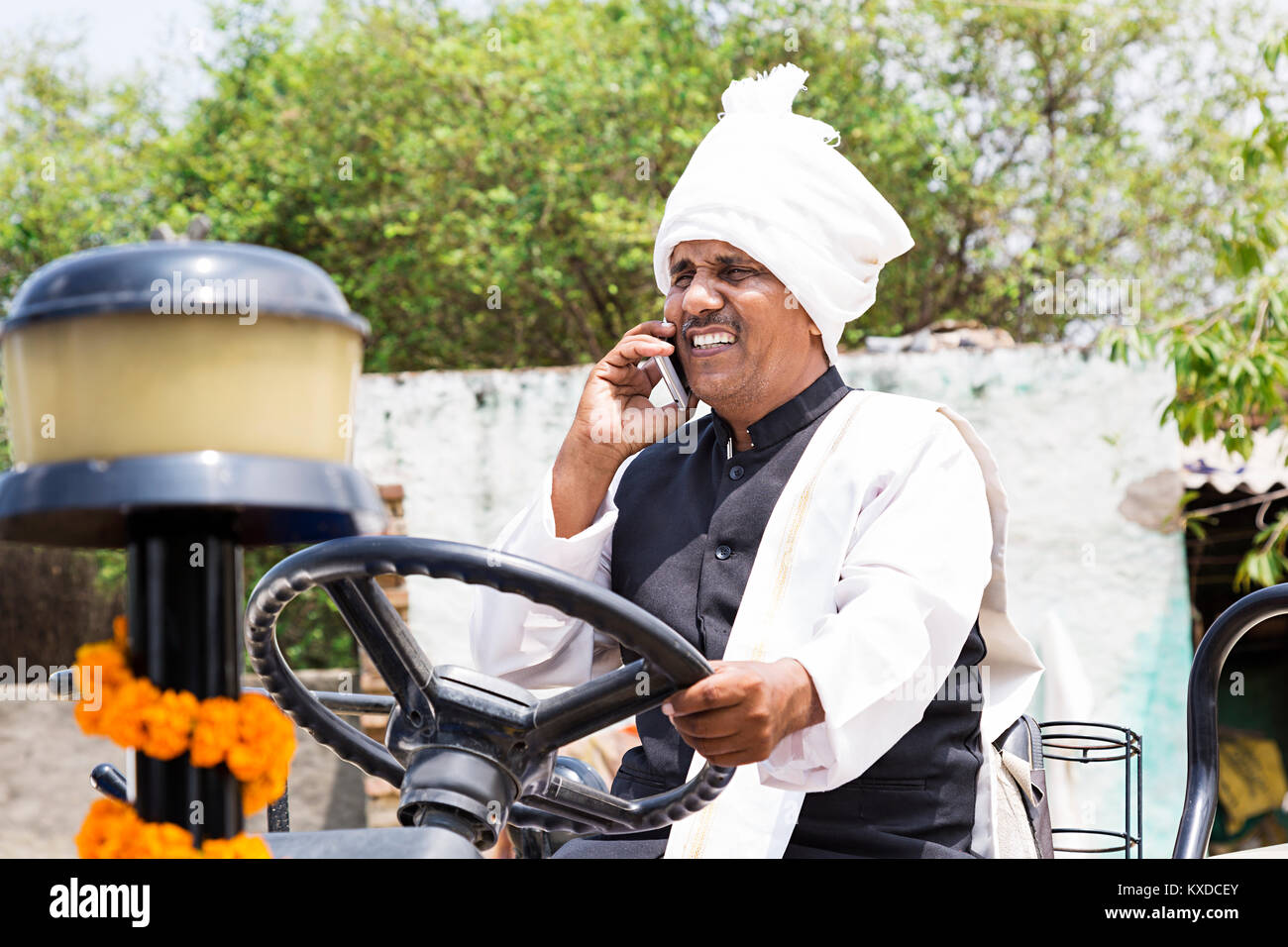 1 Indian Rural Farmer talking Mobile phone while driving Tractor Stock ...