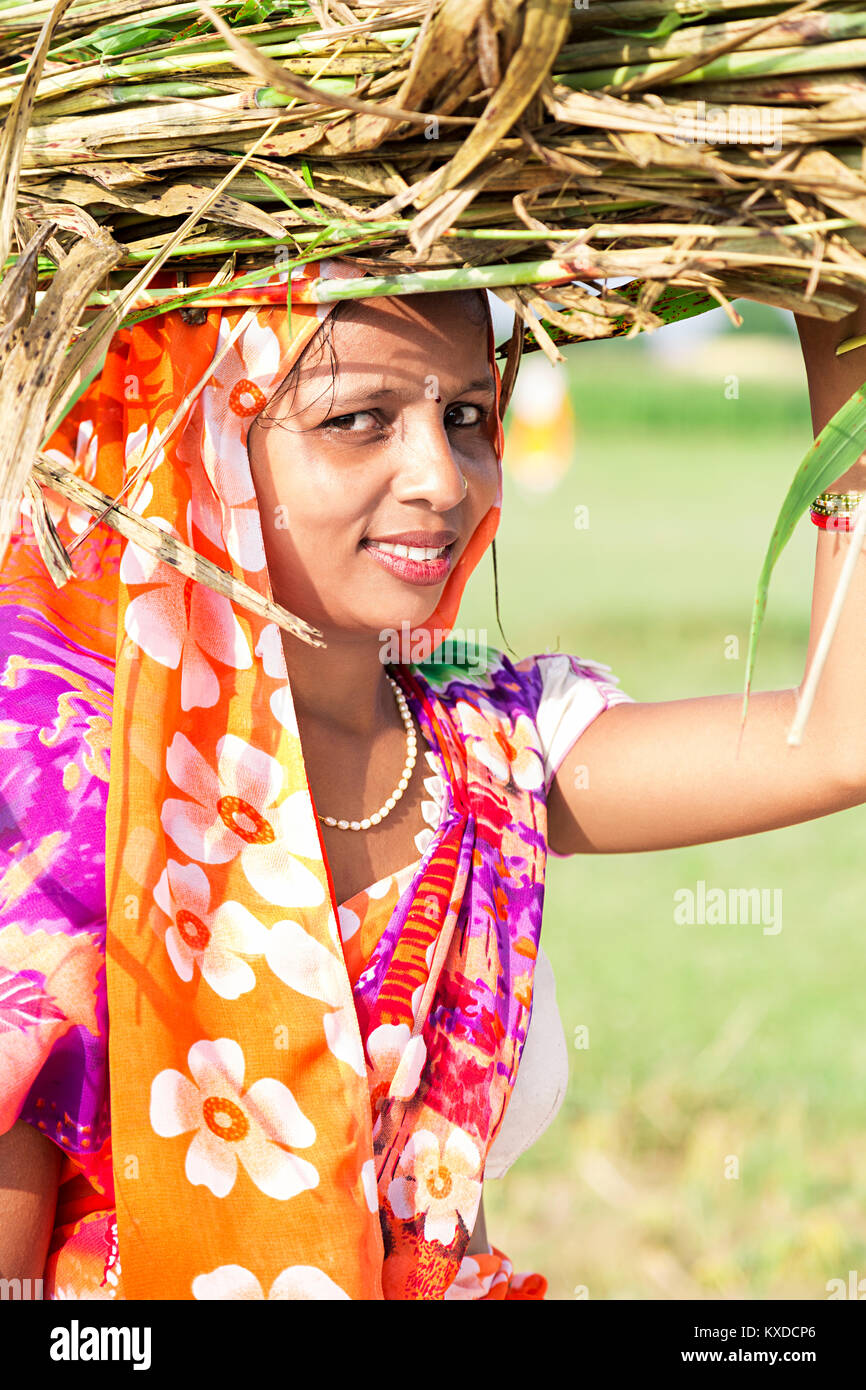 Indian rural villager woman carrying hi-res stock photography and ...