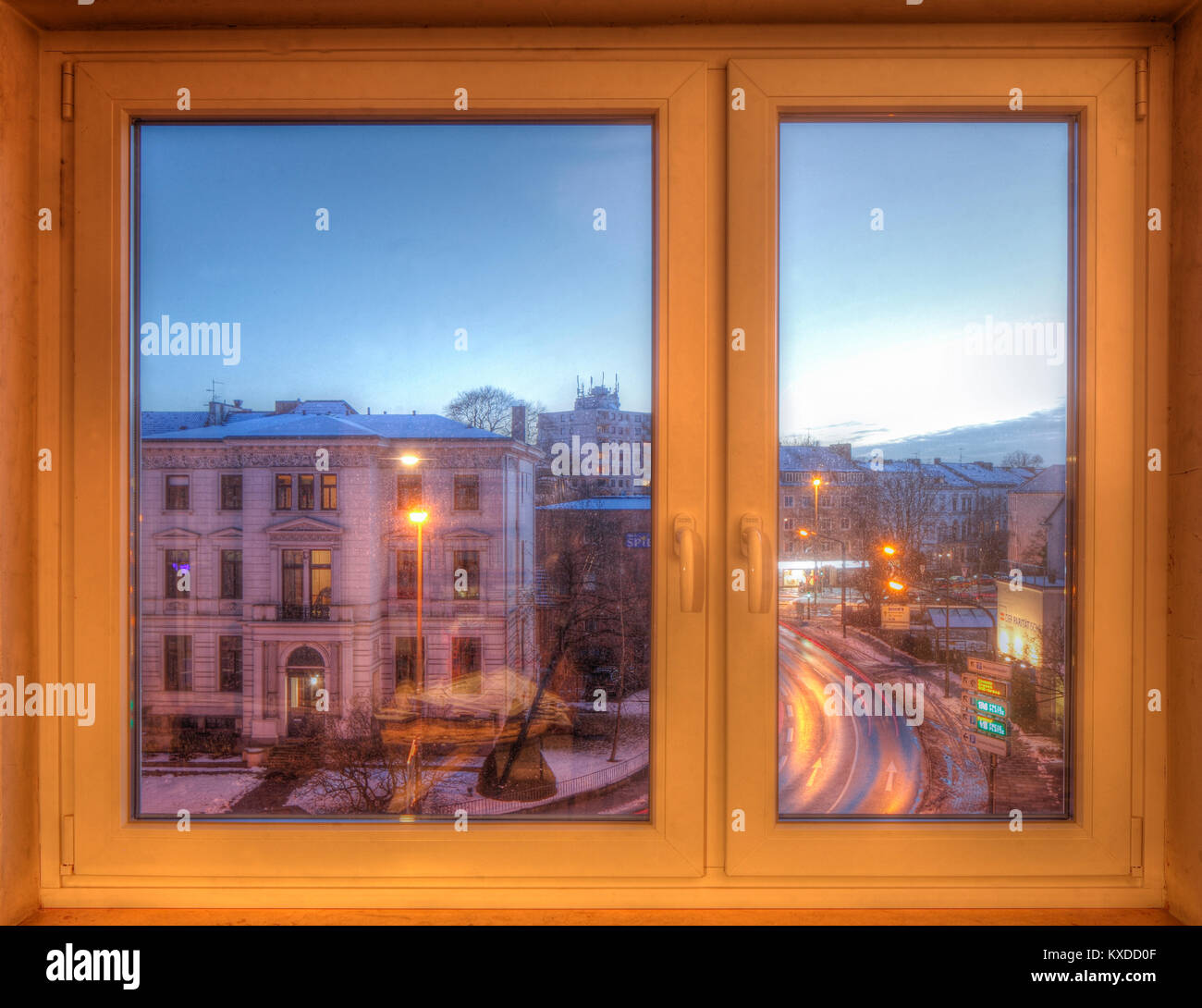 View through closed windows from the inside onto snowy roads and houses ...