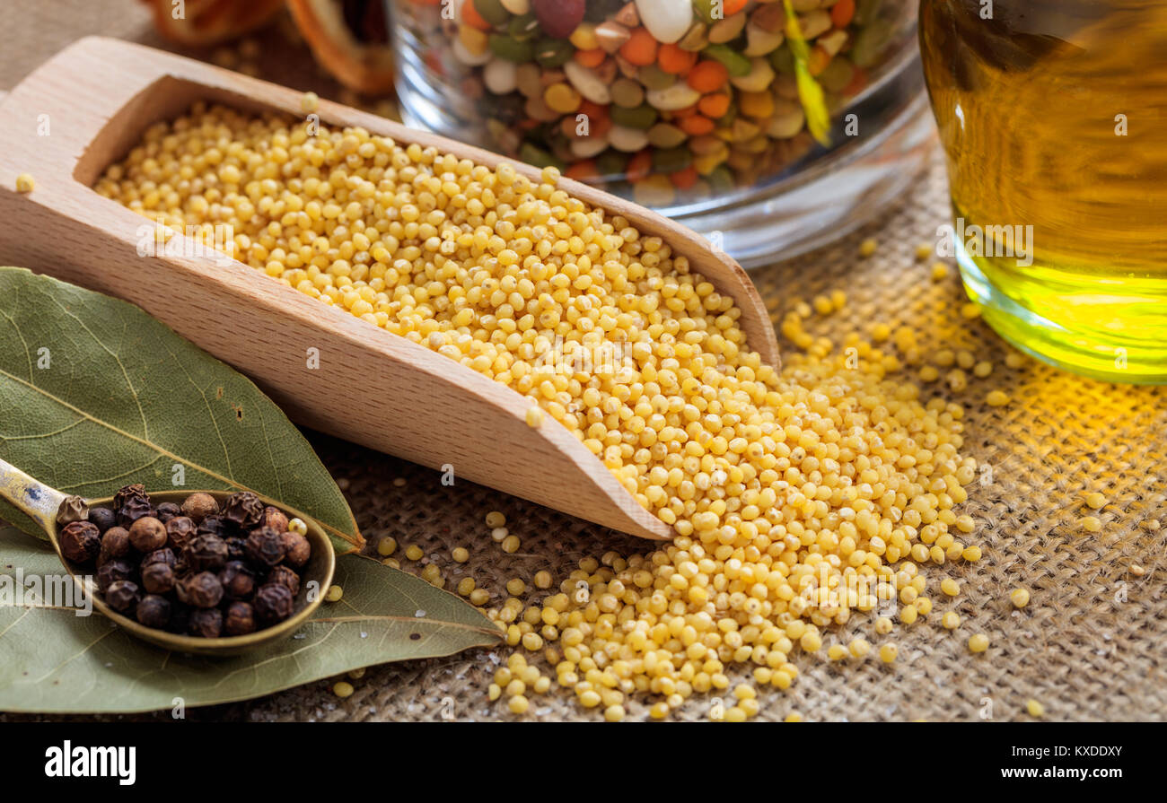 Wooden scoop with millet on a burlap Stock Photo - Alamy