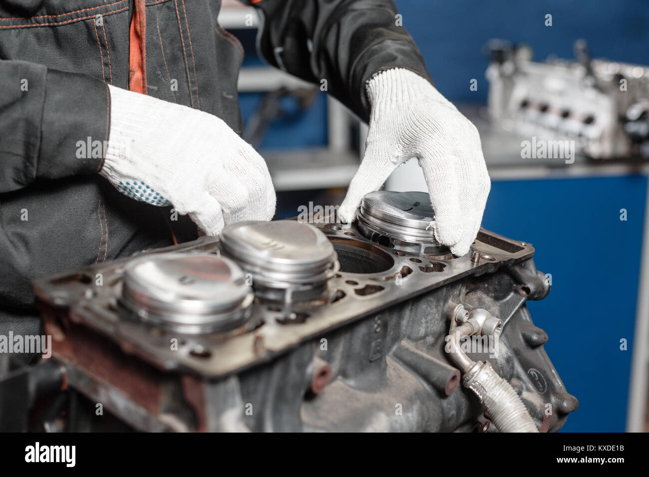 the mechanic installs a new piston. Disassemble engine block vehicle ...