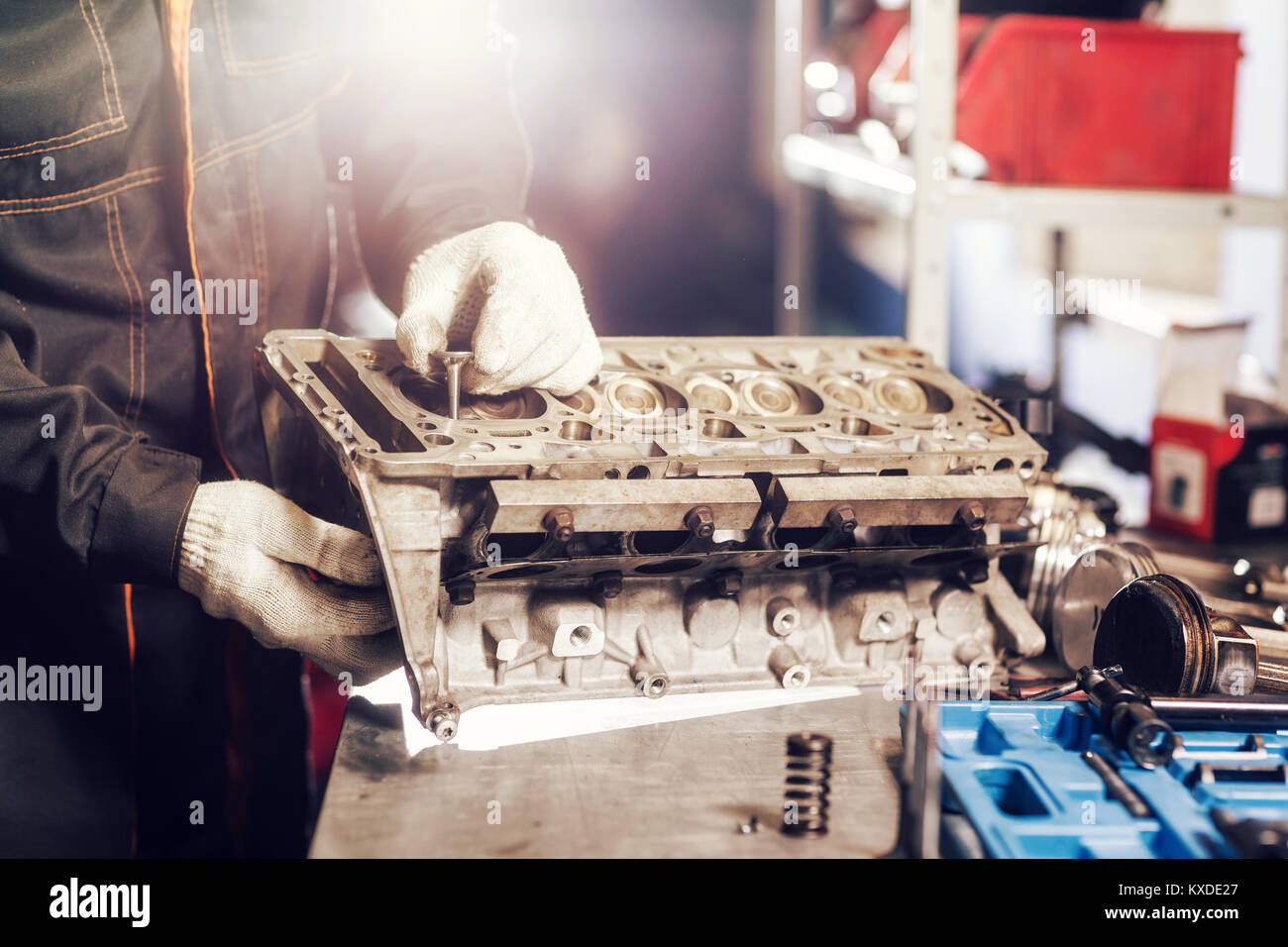 the mechanic installs a new valve. Disassemble engine block vehicle ...