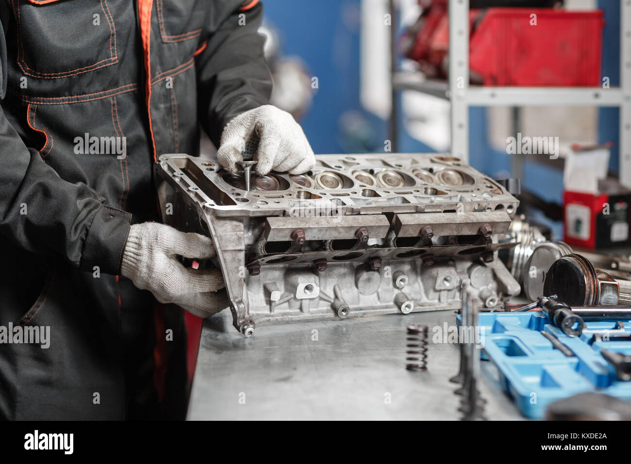 the mechanic installs a new valve. Disassemble engine block vehicle ...