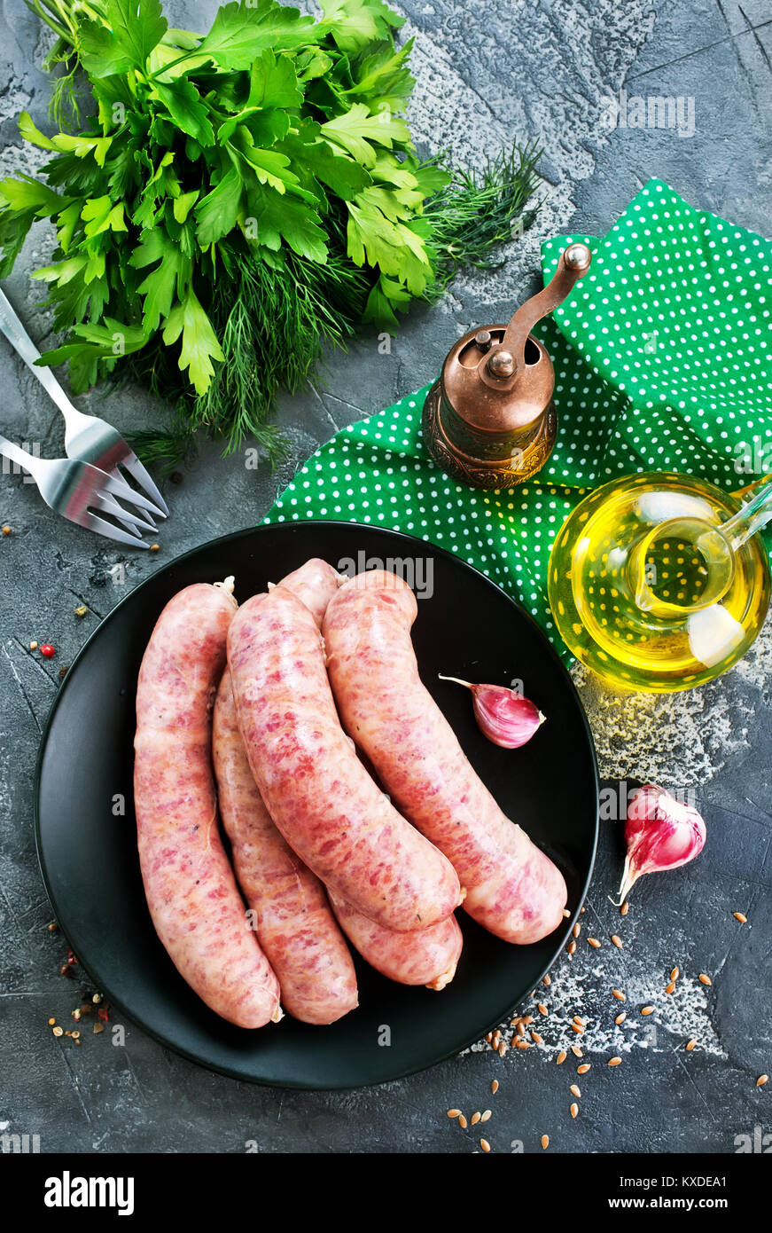 raw sausages with salt and spice on a table Stock Photo - Alamy