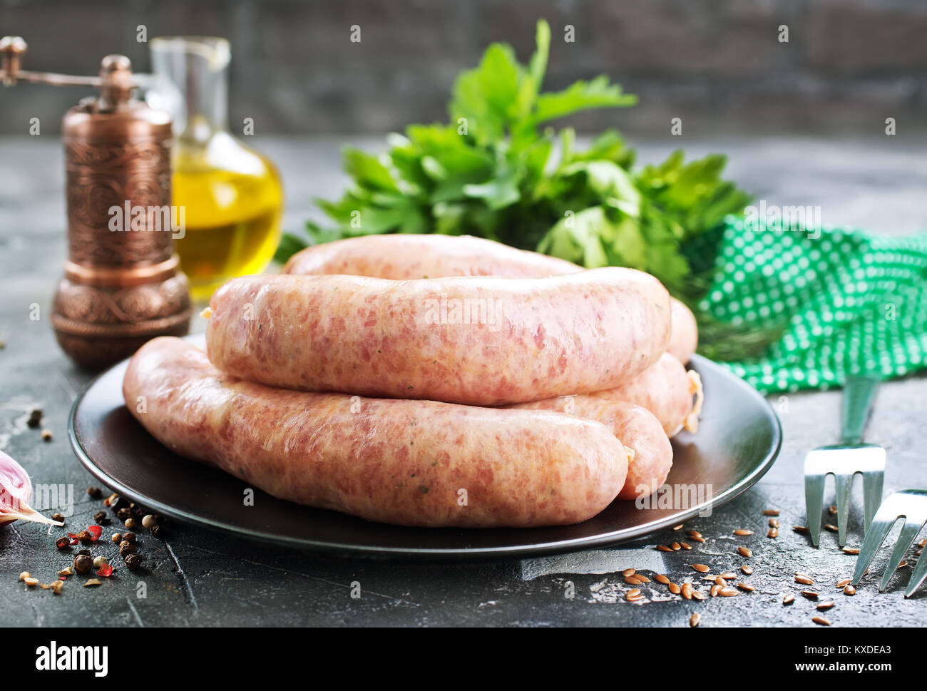 raw sausages with salt and spice on a table Stock Photo - Alamy