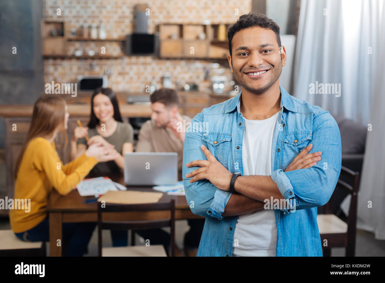 Young smart worker feeling happy while standing and smiling Stock Photo ...