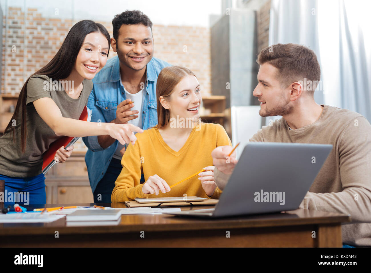 Enthusiastic students looking at the screen while generating wonderful ...