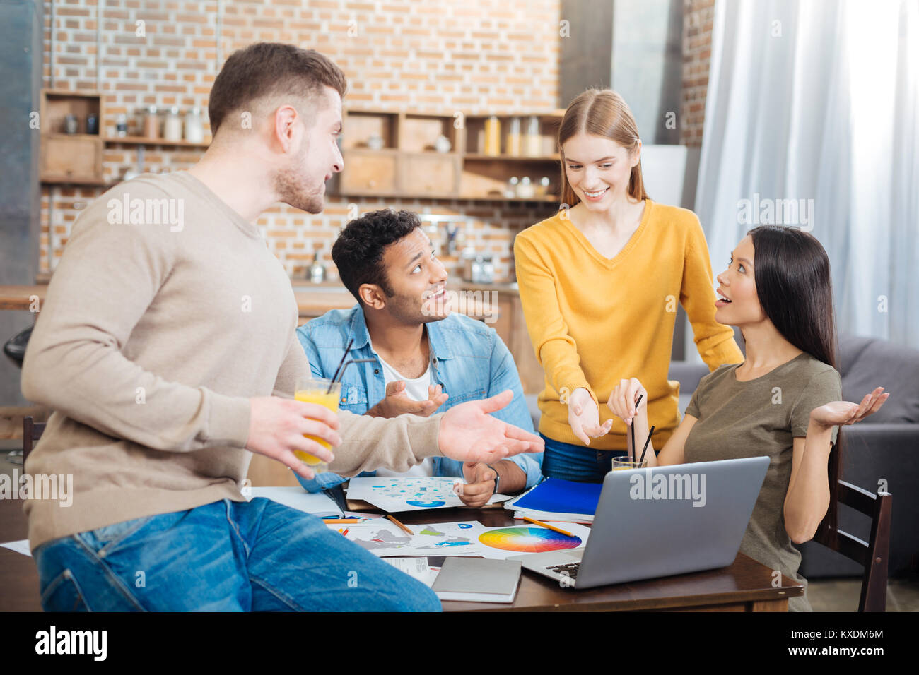Surprised students looking at their friend and feeling glad Stock Photo ...