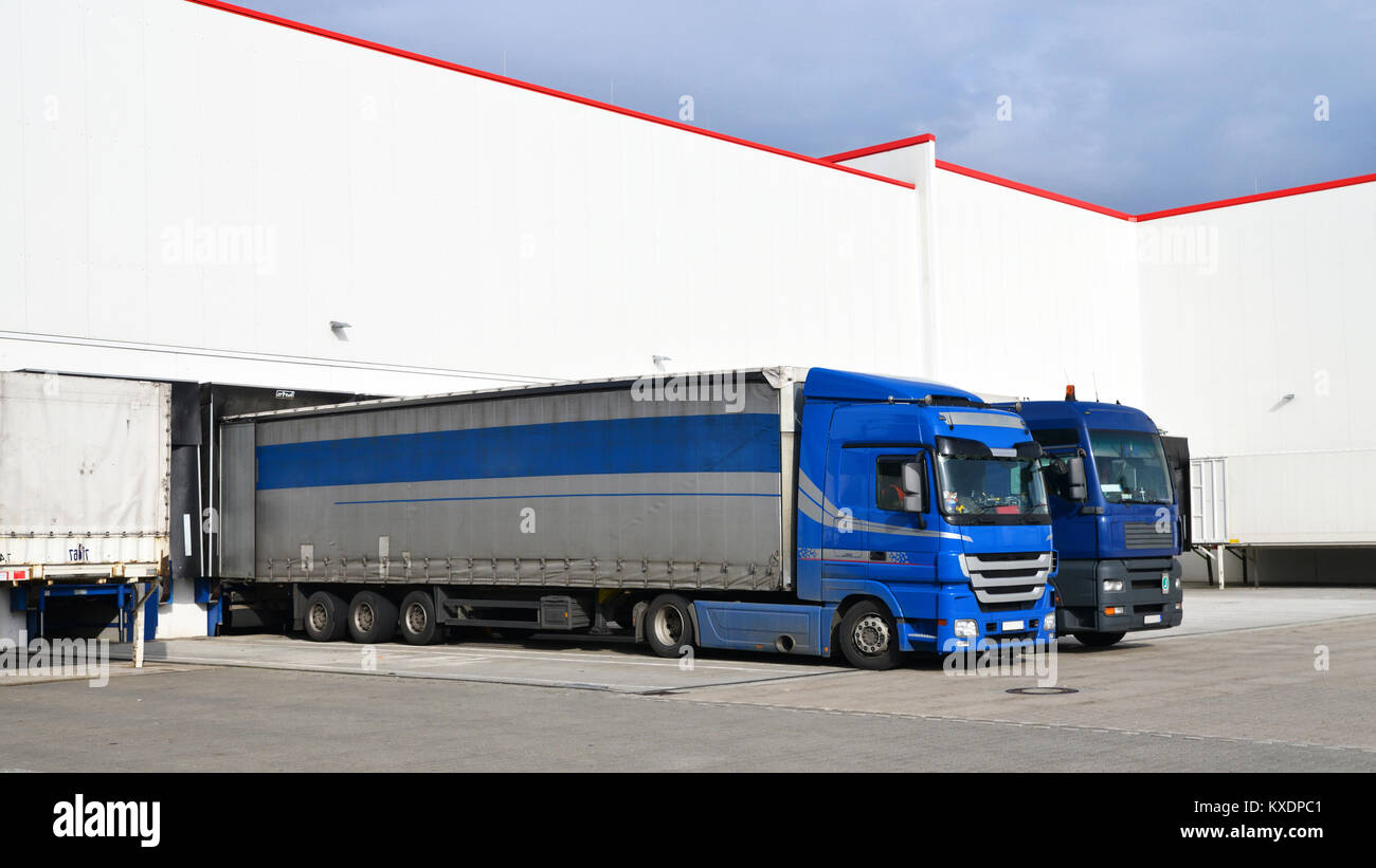 trucks are loaded with goods at the depot in a shipping company Stock ...