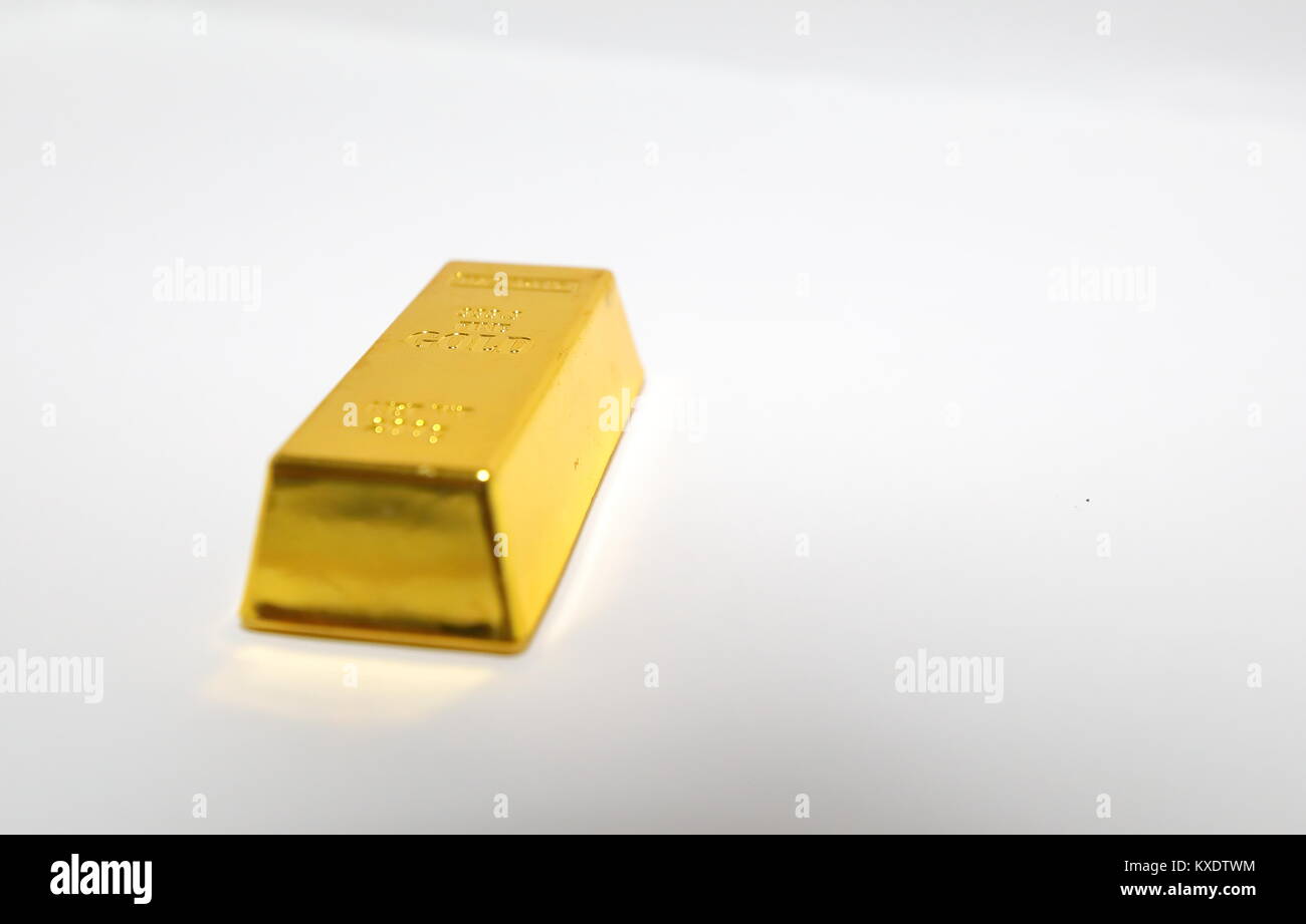 One gold bar ingot isolated Stock Photo - Alamy