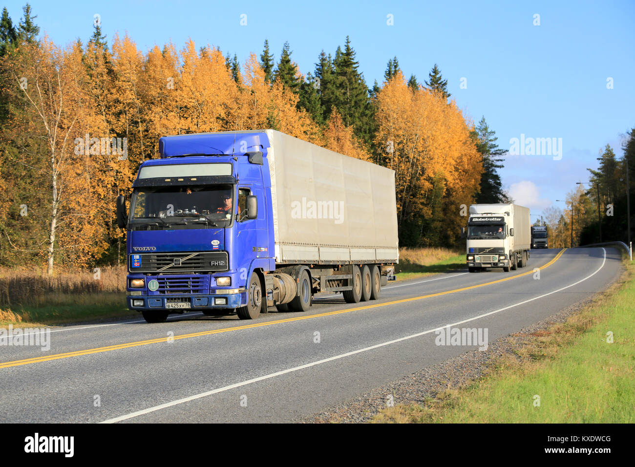 KAARINA, FINLAND - OCTOBER 4, 2014: Three Volvo FH12 trucks are driven ...