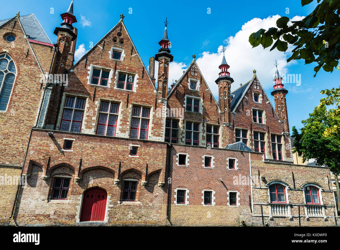 Old traditional houses along of a canal in the medieval city of Bruges ...