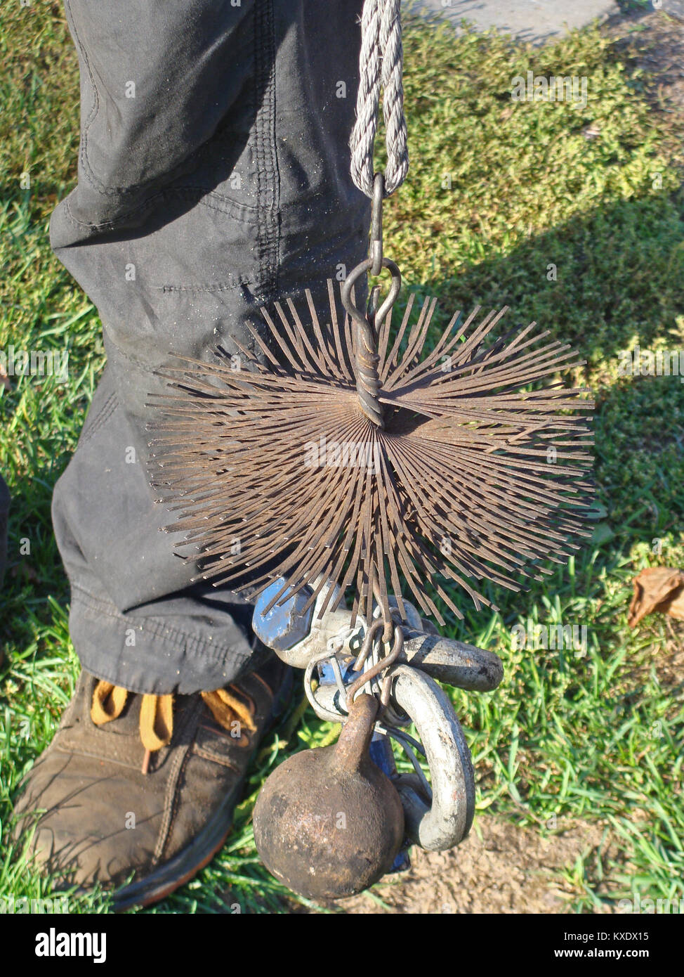 Chimney sweeper tools round wire brush with weight and rope Stock Photo ...