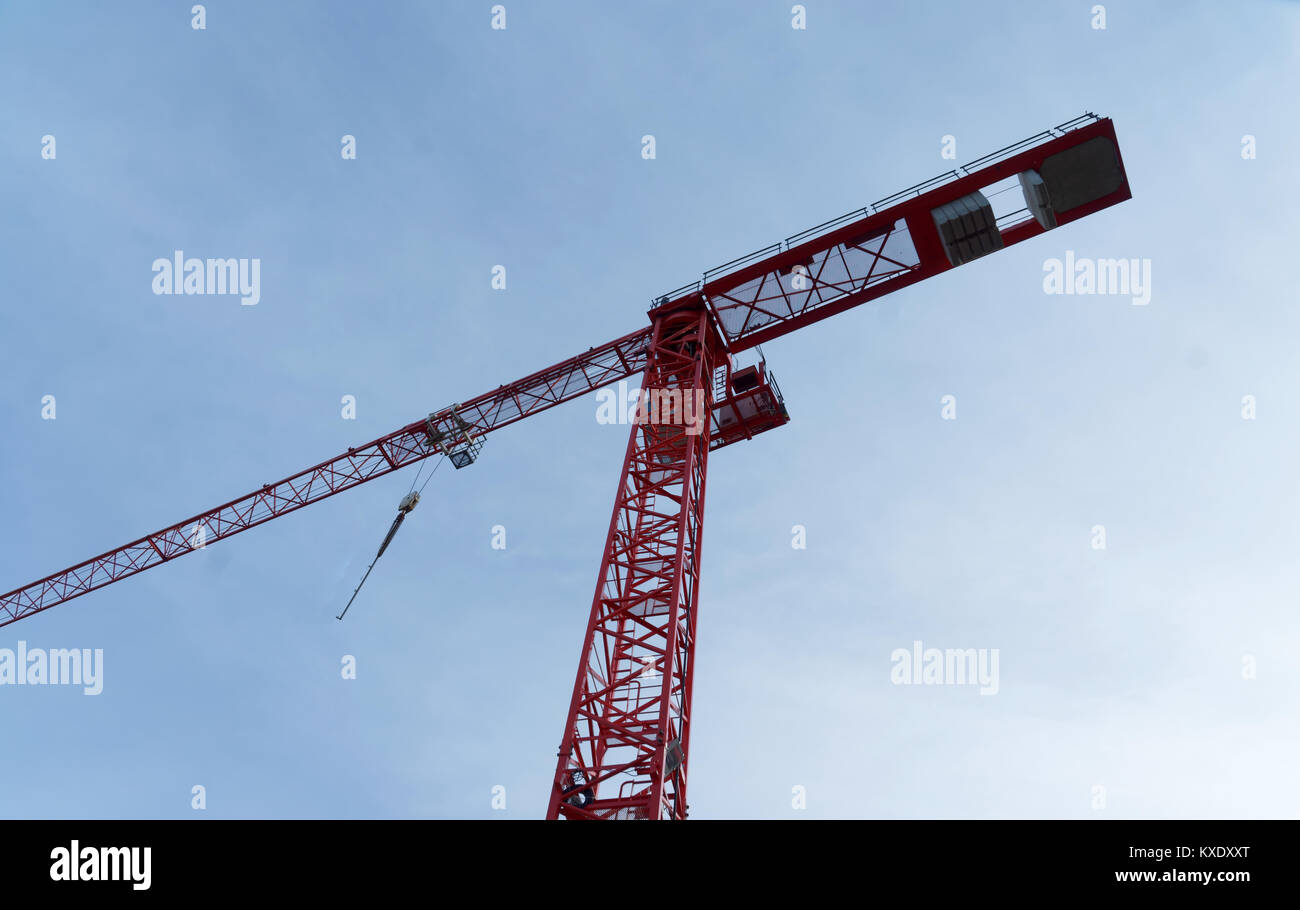 Red high construction crane on a building site, oblique picture of an ...