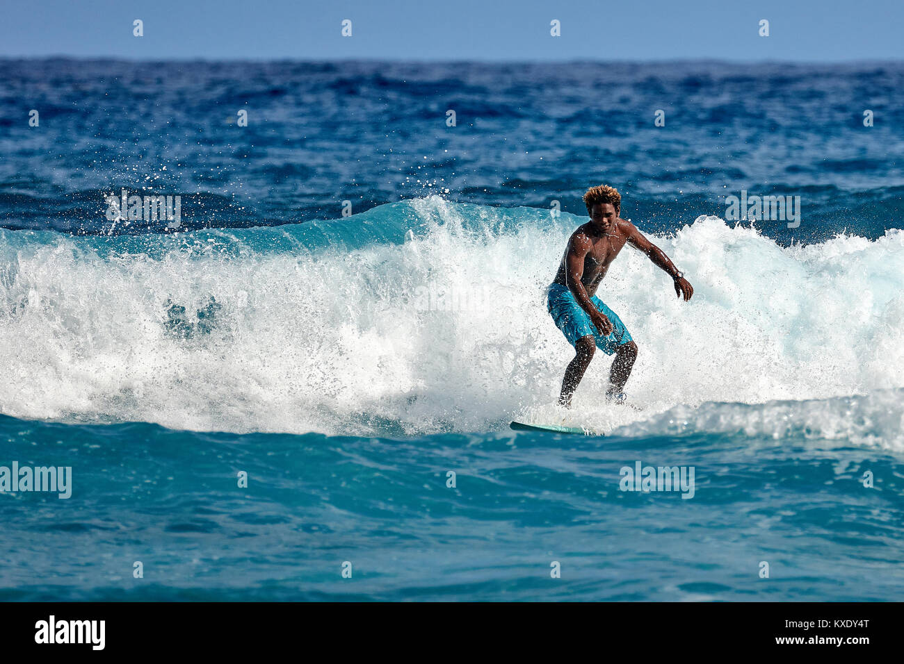 Professional surfer, surfing a wave. Surfer carves a radical off-the ...