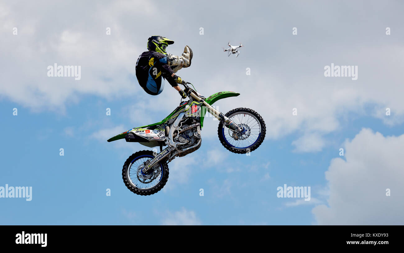 Professional rider at the FMX (Freestyle Motocross) make an acrobatic ...
