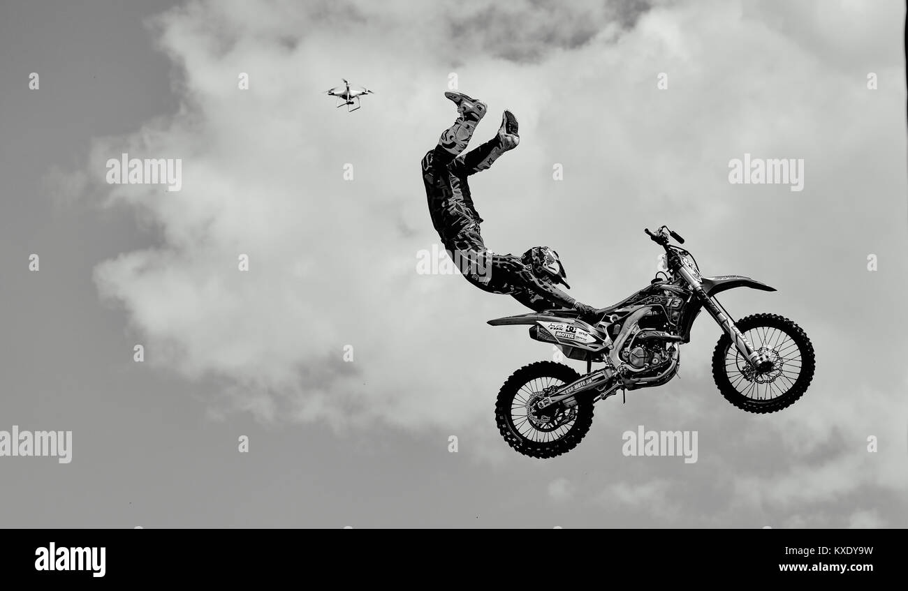 Professional rider at the FMX (Freestyle Motocross) make an acrobatic ...