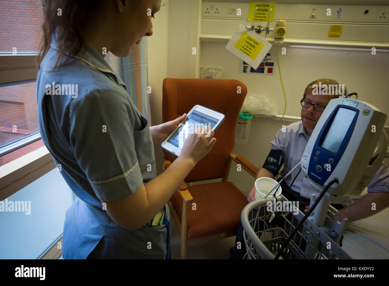 Staff nurse Charlotte Howden, inputting data into an iPad on a ward at ...