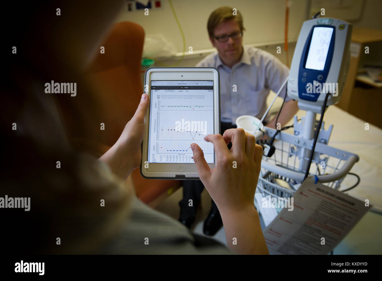 Staff nurse Charlotte Howden, inputting data into an iPad on a ward at ...