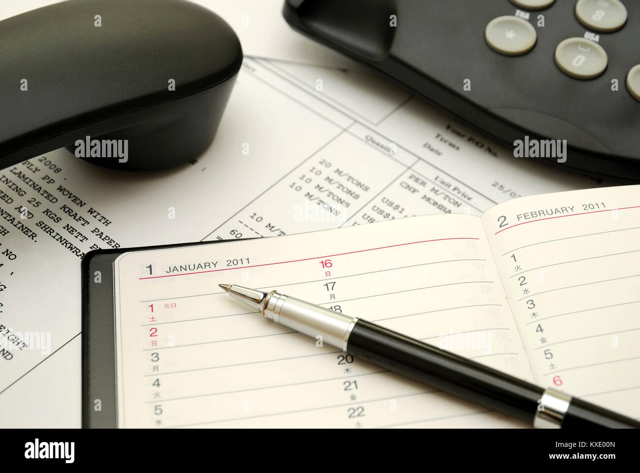 Black pen on planner with phone signifying concepts such as office and ...