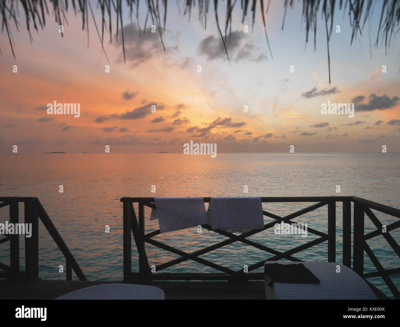 Relaxing view of open sea at dawn from water bungalow room window. The ...