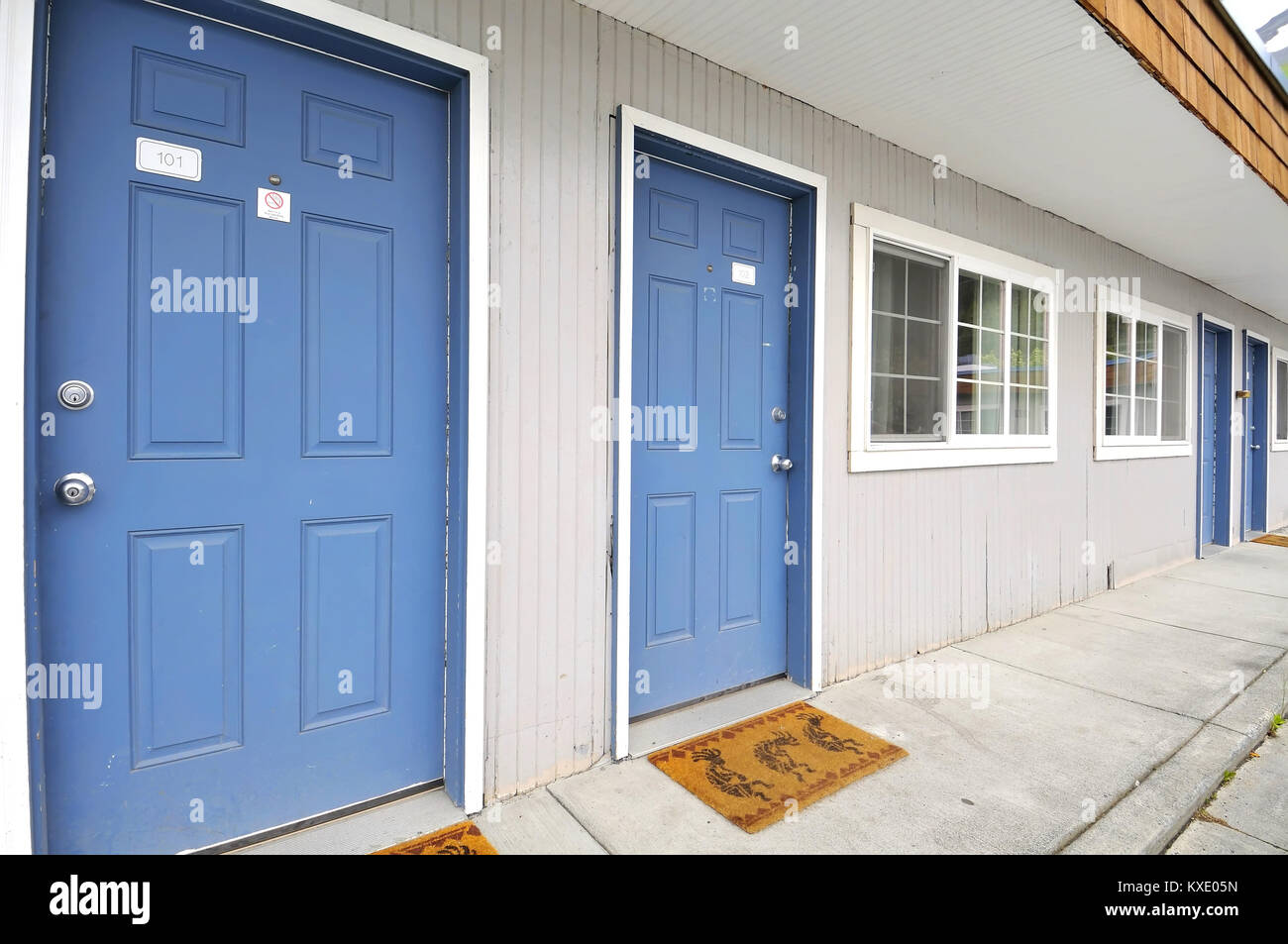 Exterior view of simple hotel with row of rooms. For backpacking and ...