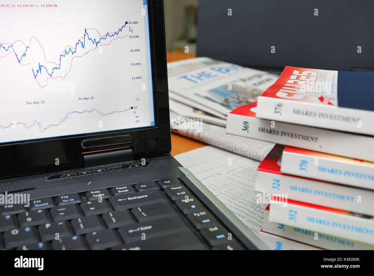 Financial books with laptop showing graphs and charts. Camera focus on ...