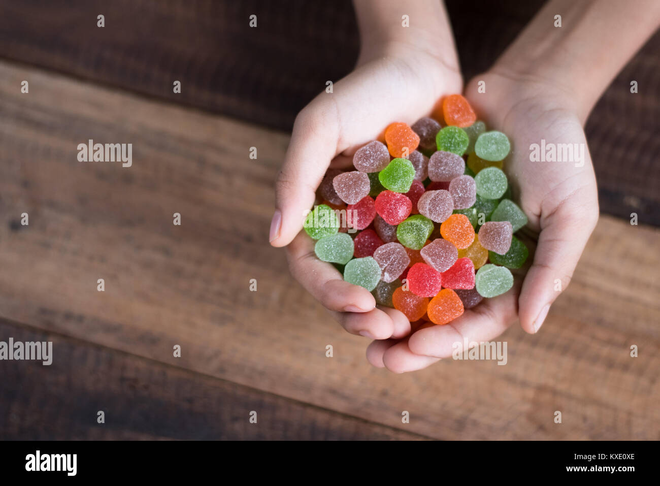 hand showing pile of gumdrop on a wooden table background Stock Photo ...