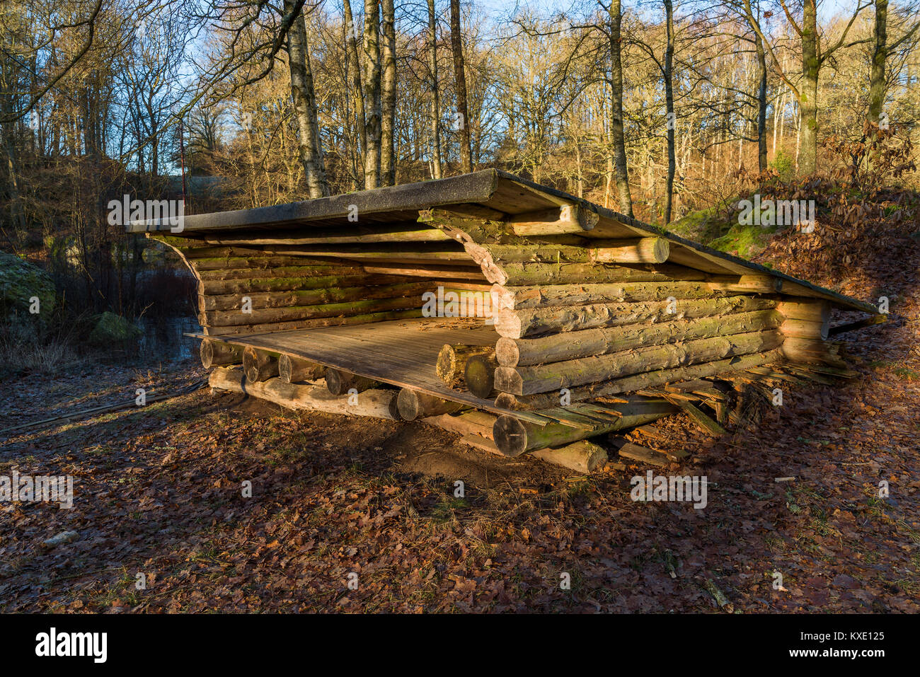 Roofed timbered wind shelter for sleepover in the wilderness Stock ...