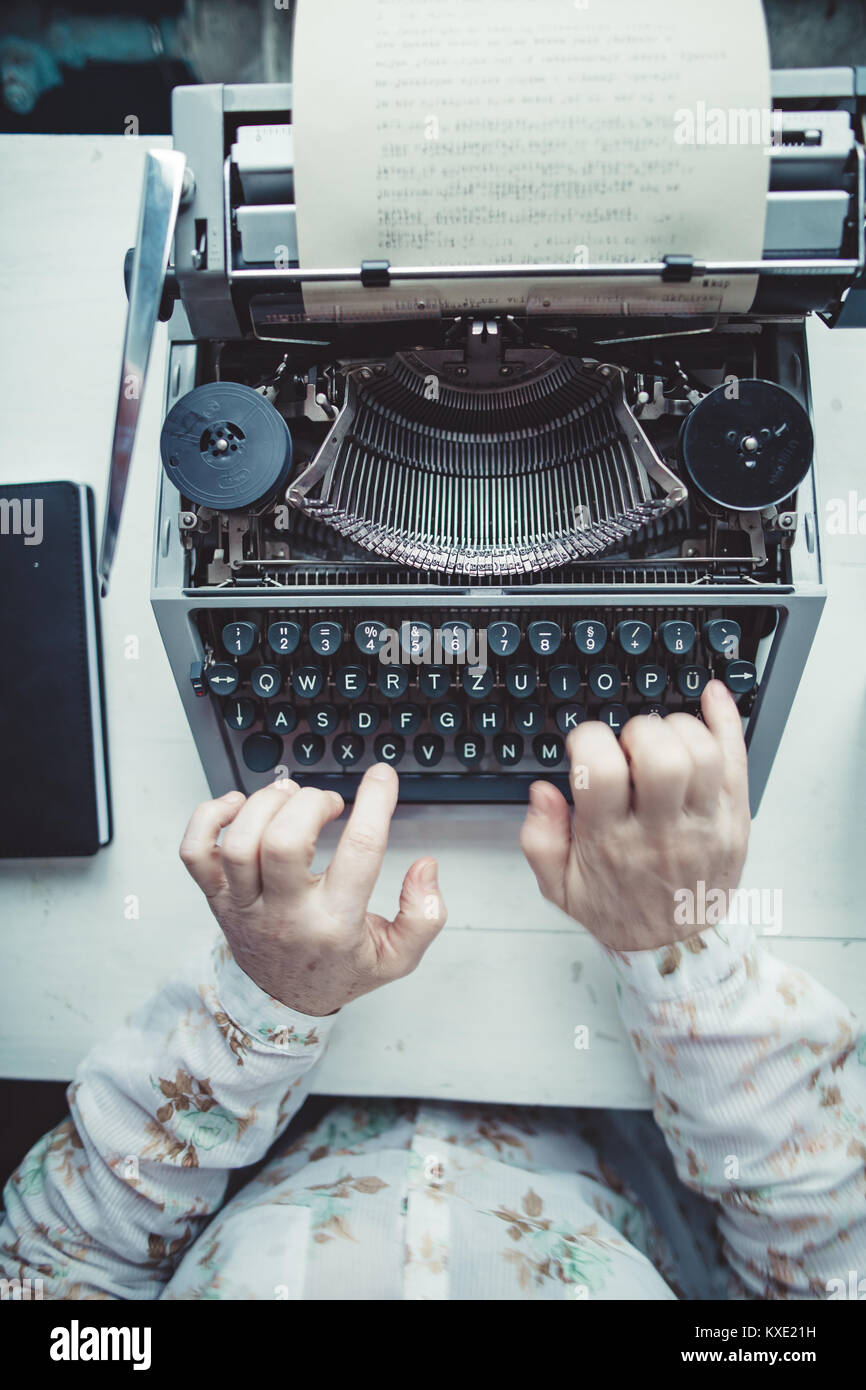 Writer typing with retro writing machine Stock Photo - Alamy