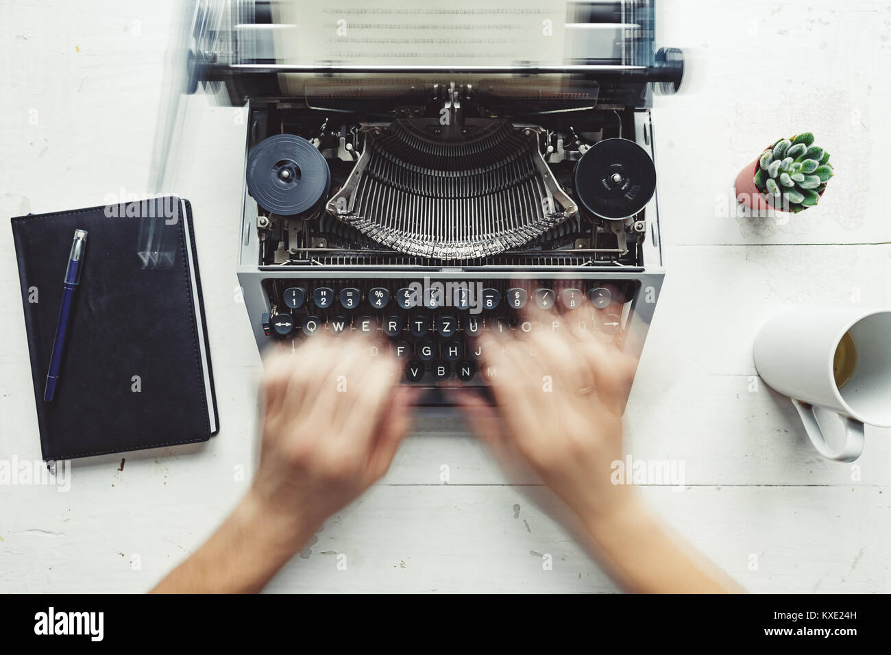 Writer typing with retro writing machine Stock Photo - Alamy