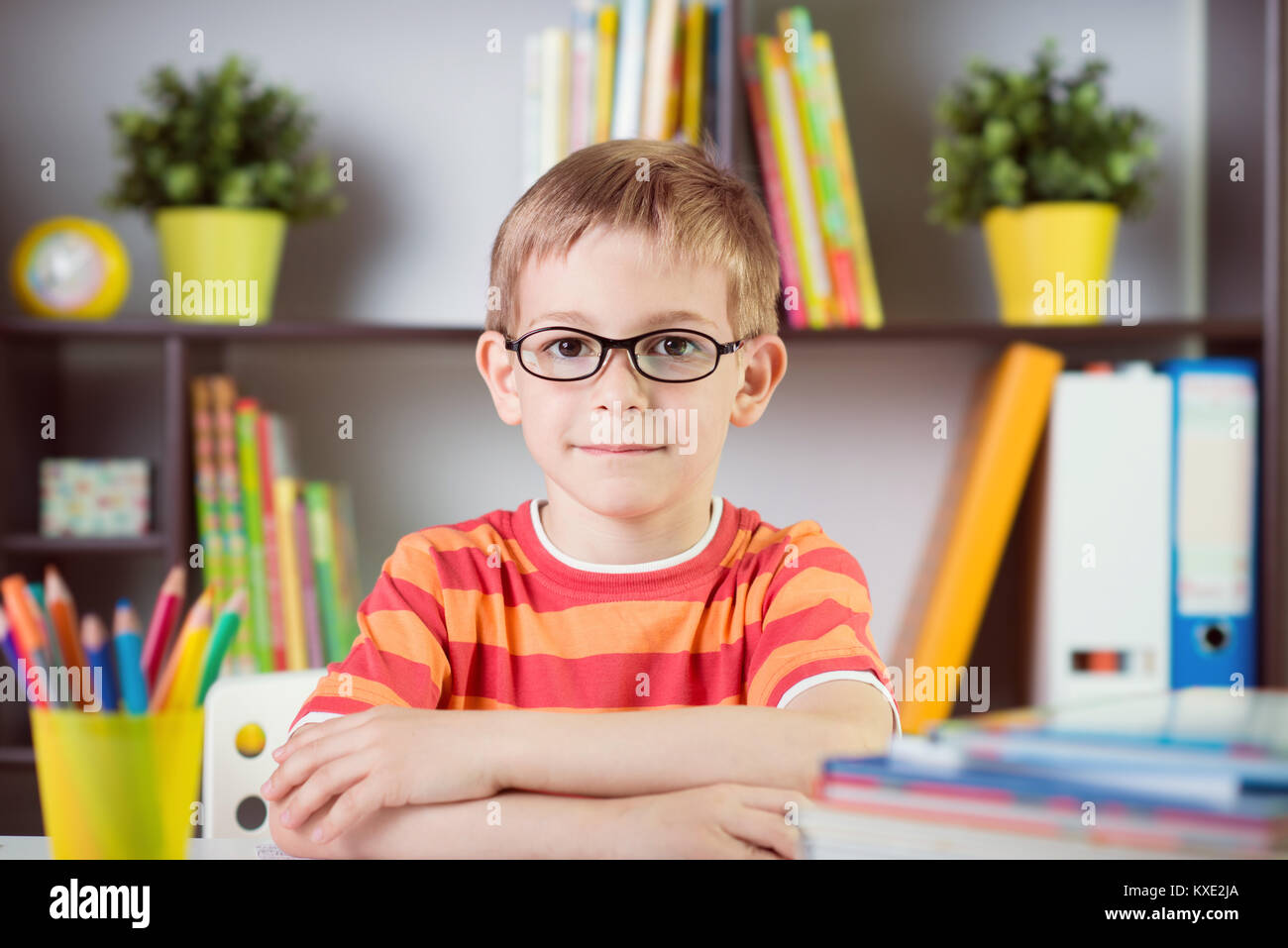 Elementary school boy at classroom desk making schoolwork Stock Photo ...