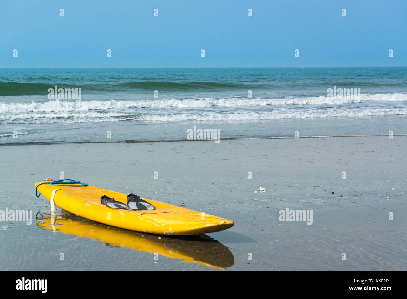 A yellow surfboard lays on Kotu Beach in The Gambia, West Africa Stock ...