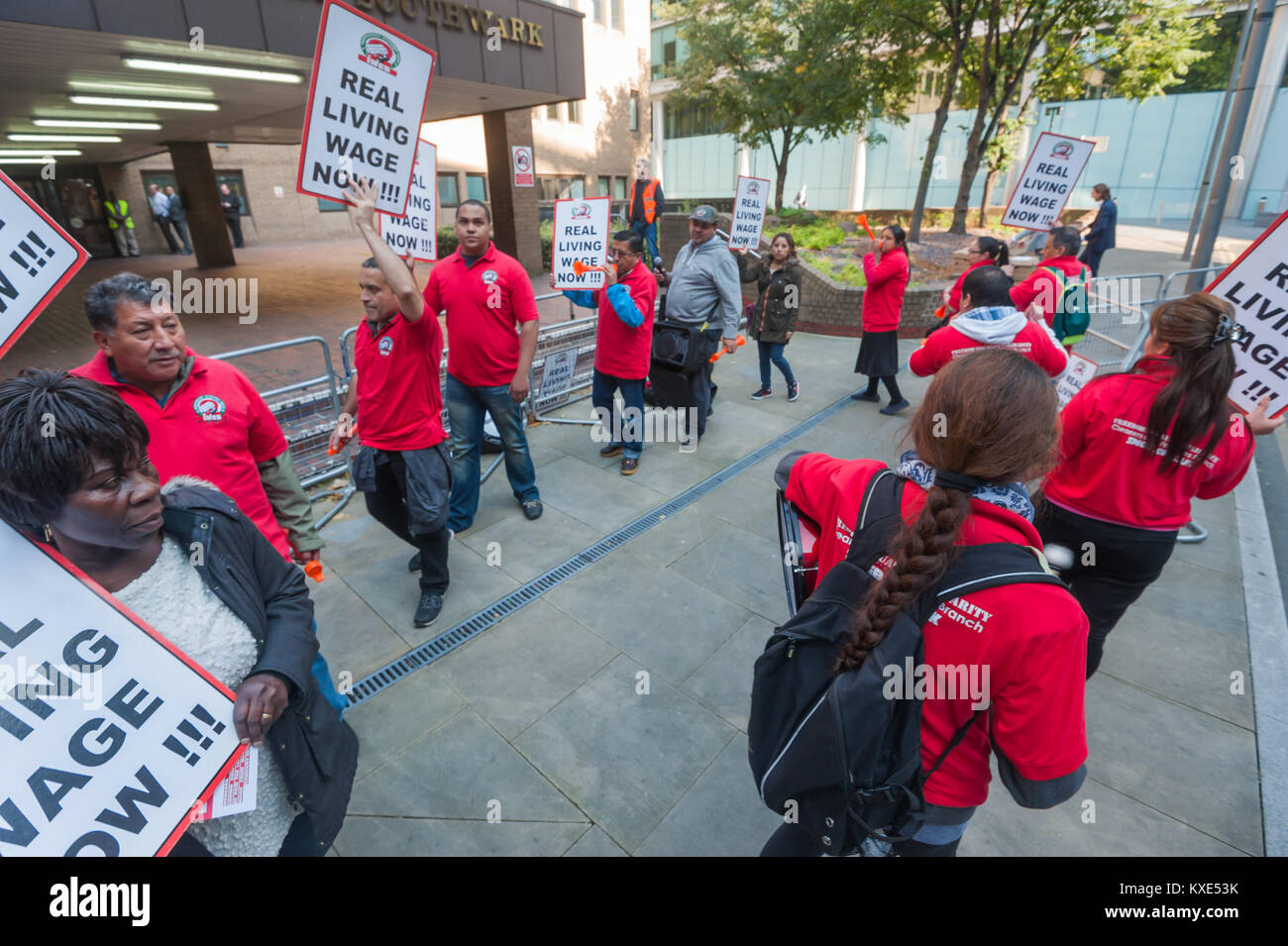 Protesters blow horns and carry posters in a circle at a noisy IWGB ...