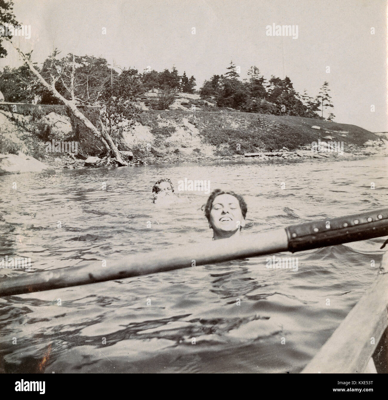 Antique circa 1905 photograph, two women swimming toward a rowboat in ...