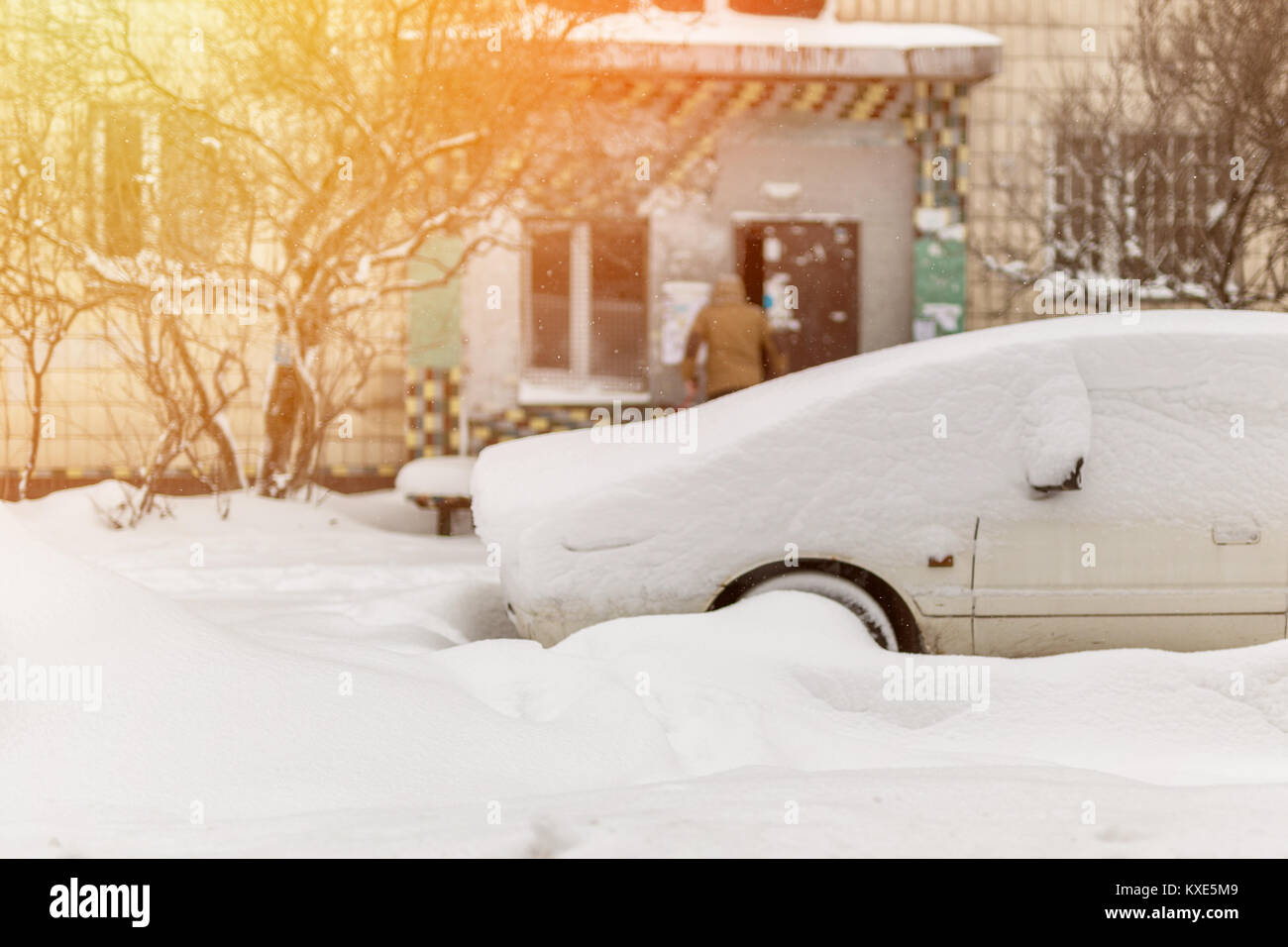 Car trapped on a street covered with big snow layer after heavy ...