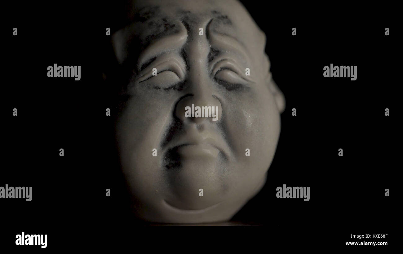 Black and white figurine of dramatic face close up. White statuette of ...