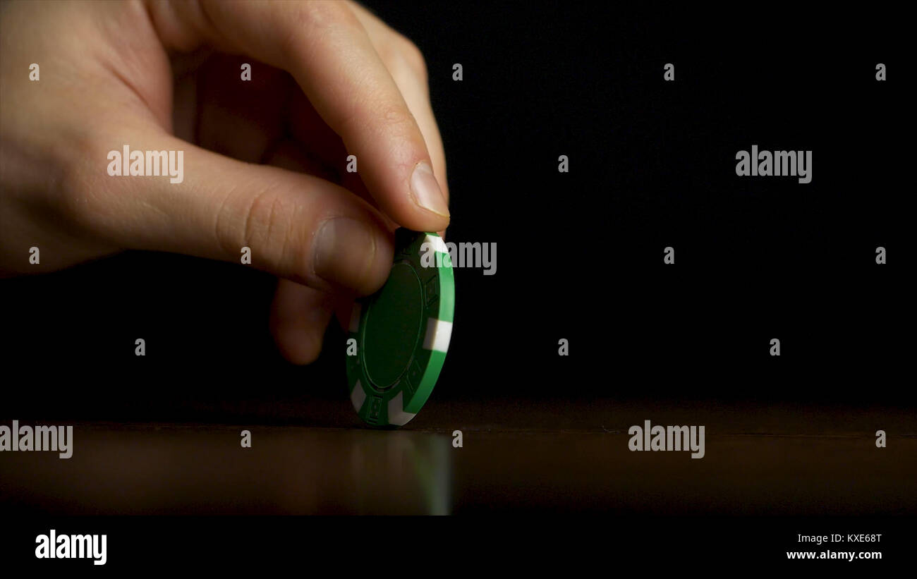 Rotation of poker chips on the table isolated on black background ...