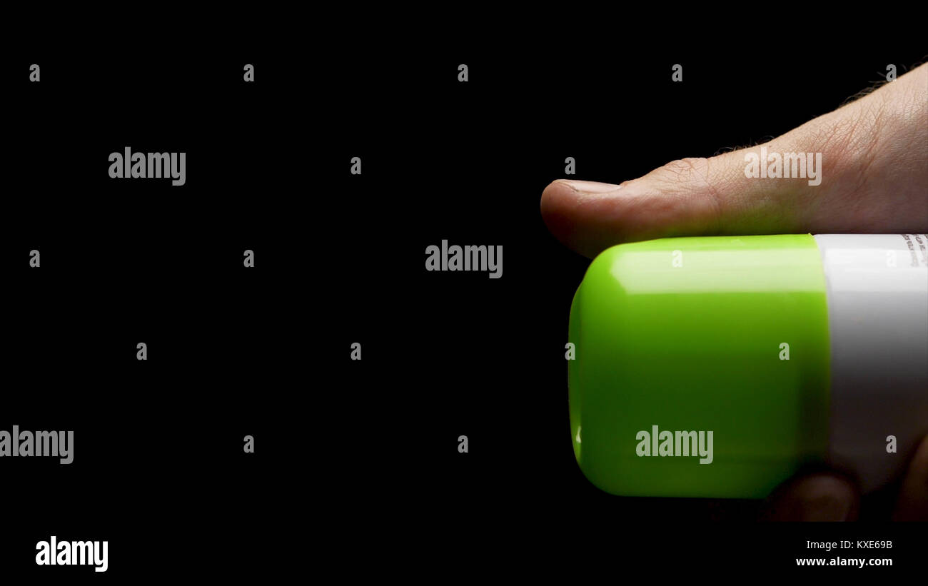Sprayed air freshener in hand isolated on black. Automatic Air ...