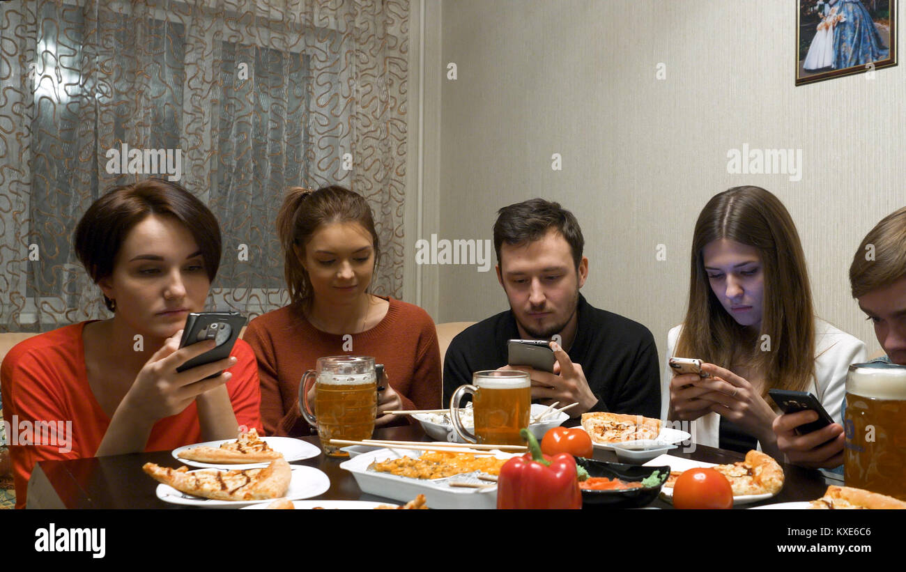 Group of friends at dinner party with all people on the table occupied ...