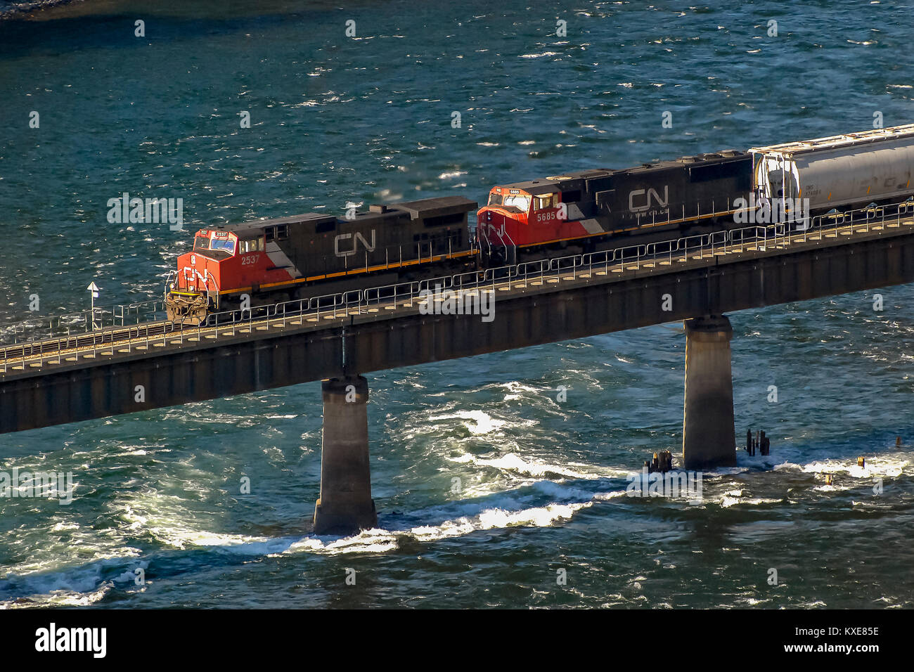 CN Rail grain train crossing Thompson River bridge near Juniper Beach ...