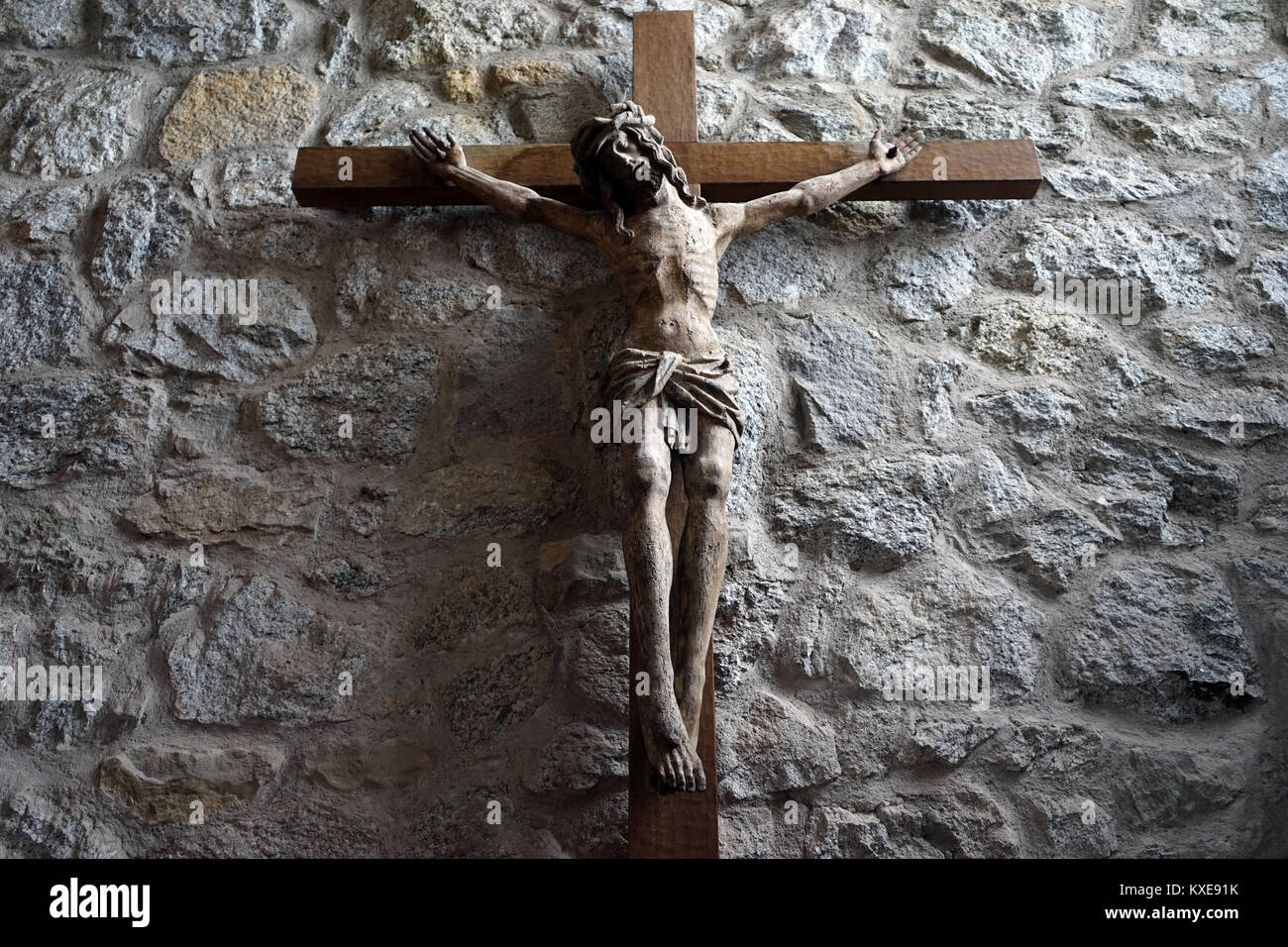 Wooden crucifix on the stone wall of church in Switzerland Stock Photo ...