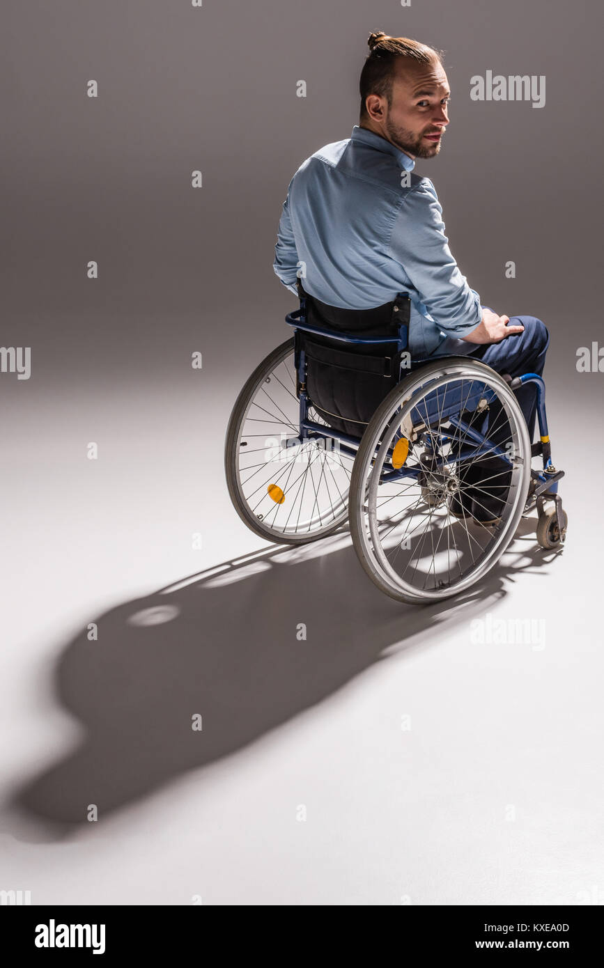 man on wheelchair casting shadow Stock Photo - Alamy