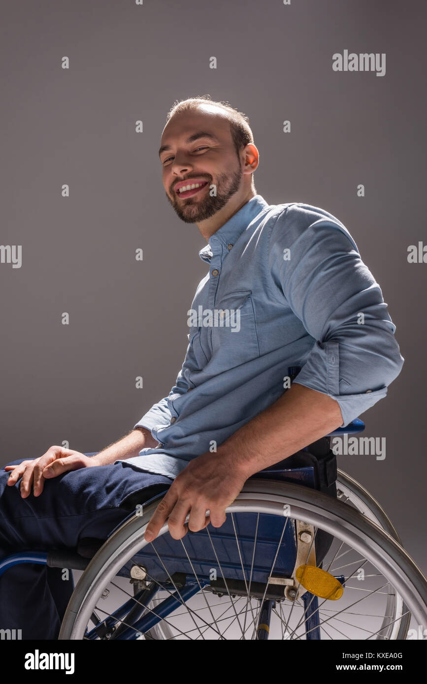 Smiling man in wheelchair Stock Photo - Alamy