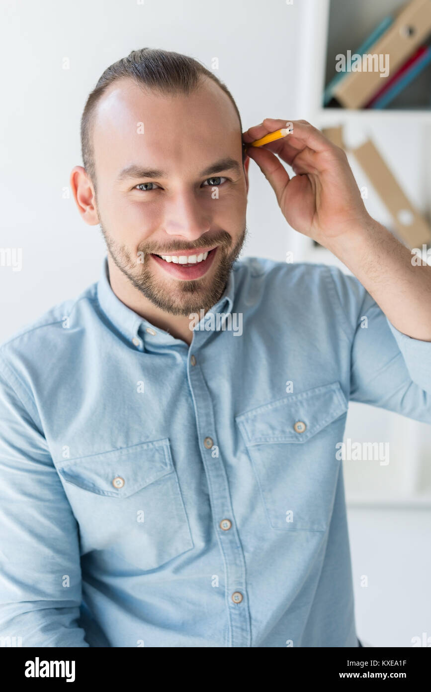 man with pencil behind ear Stock Photo - Alamy