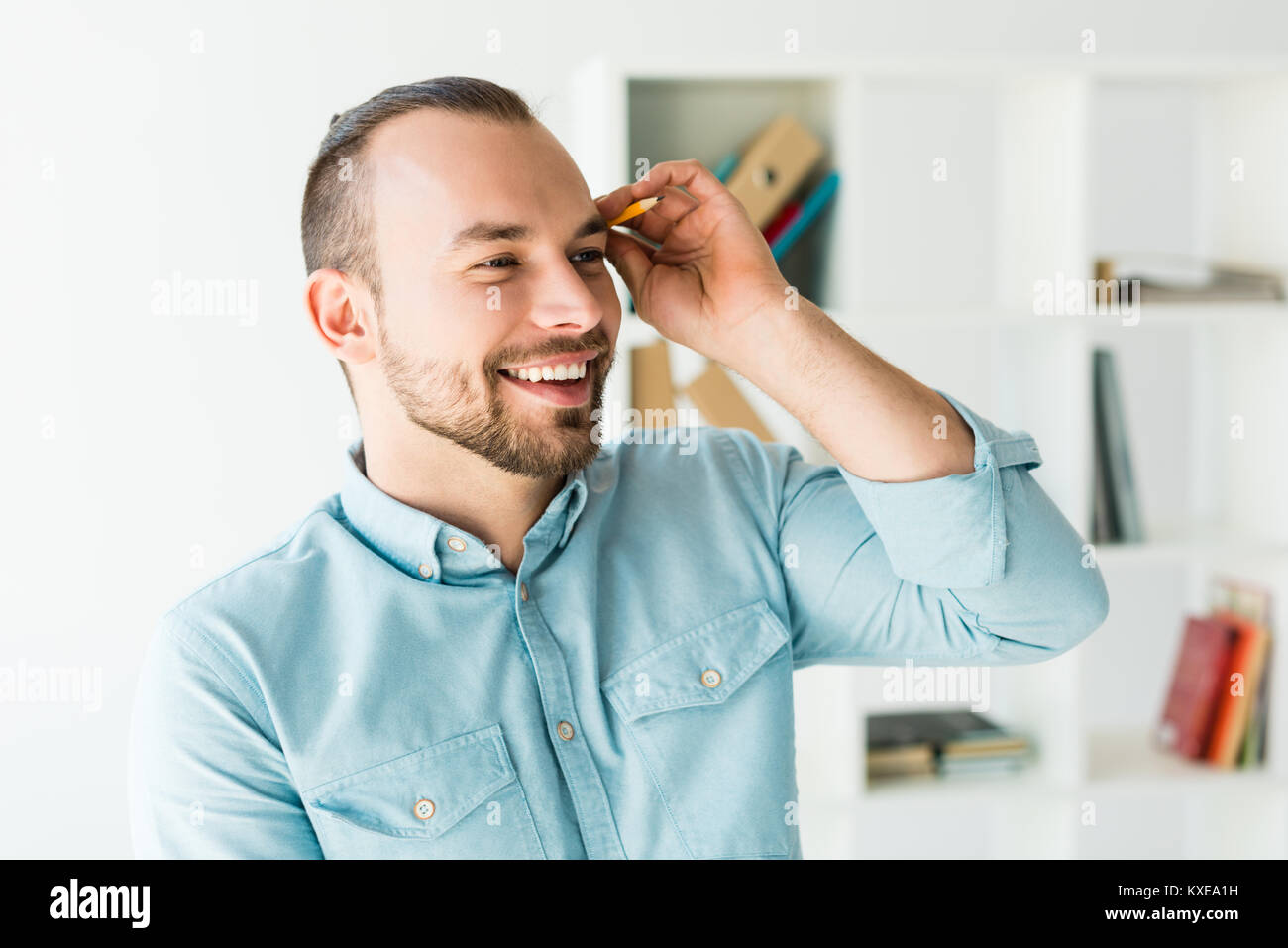 Smiling man in office Stock Photo - Alamy