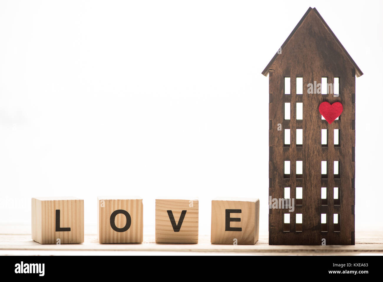 Wooden block cubes with love sign and wooden house model isolated on ...