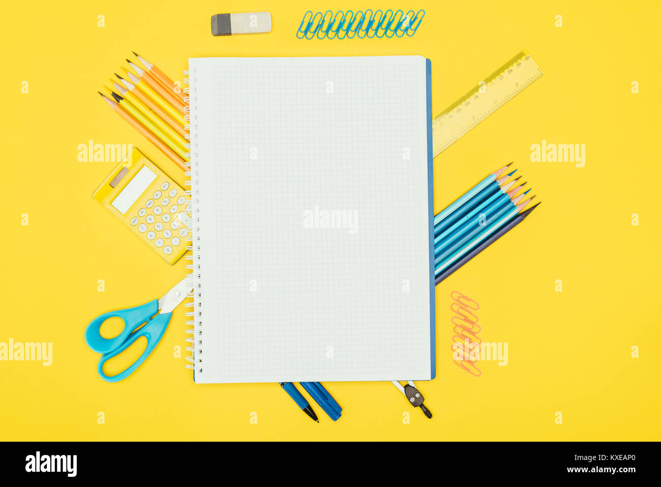 Top view of composition of colorful school supplies with blank notebook ...